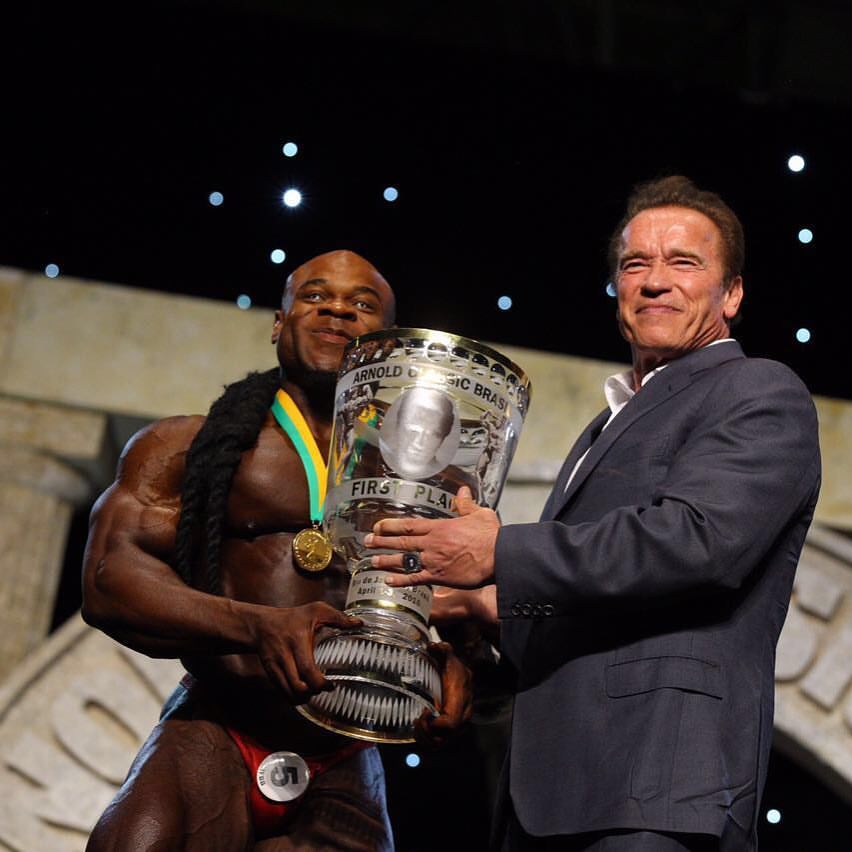 Arnold Schwarzenegger giving away Arnold classic winner award to Kai ...